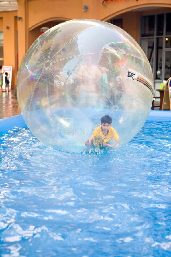Boy in floating ball stock photo. Image of surface, inflated - 5853434