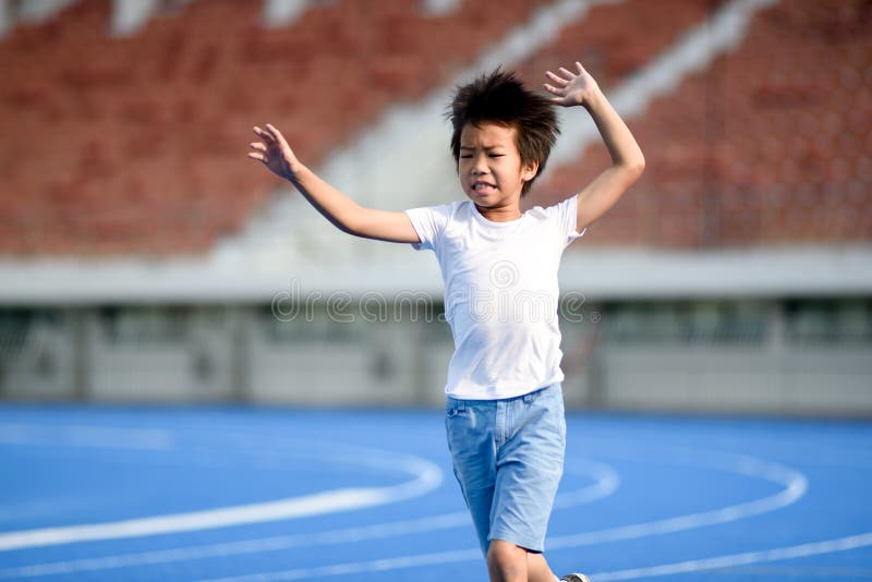 Young Boy Running on Blue Track Stock Image - Image of kids, runner ...