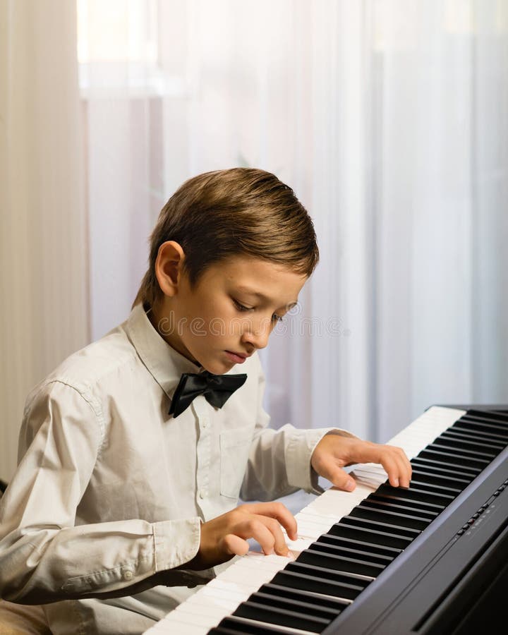 Young Boy s Piano Practice stock image. Image of keyboard - 296246097