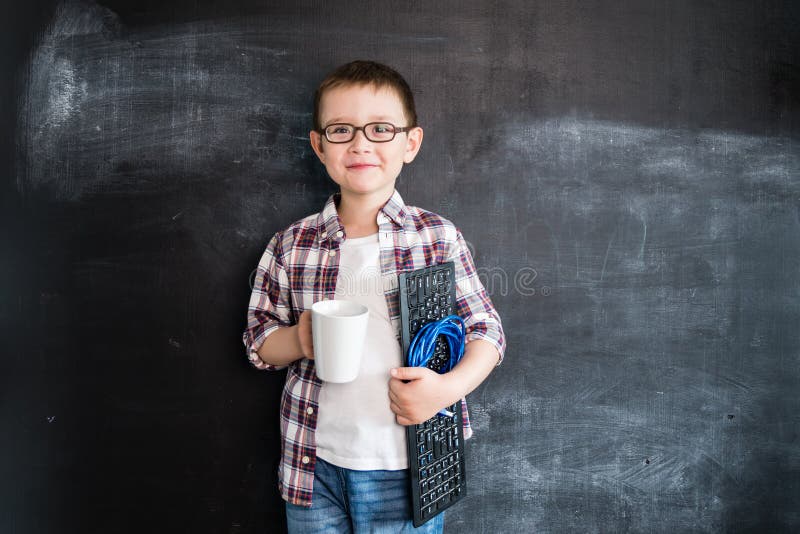 Young Boy`s Standing with Keyboard and Network Wire Near Blackboard ...