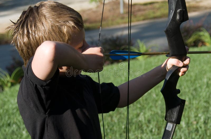 Young Boy Shooting Arrow stock photo. Image of archer - 3336442