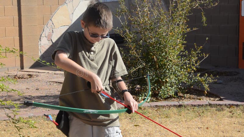 Young Boy Shooting a Bow and Arrow Stock Footage - Video of archery ...