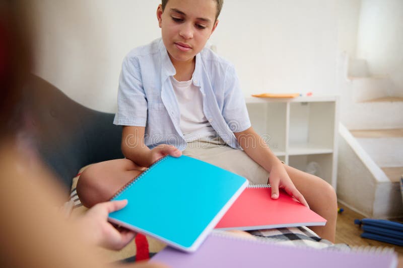 Boy Sharing Colorful Notebooks Together Stock Image - Image of ...
