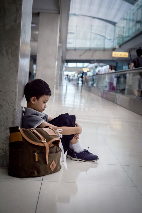 Young Boy Sitting Alone in a Hallway Stock Photo - Image of lonely ...
