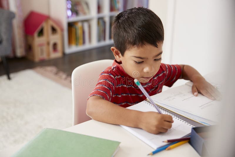 Young Boy Sitting at Desk in Bedroom Doing Homework Stock Photo - Image ...