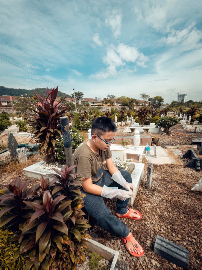 Young Boy is Sitting at the Graveyard Looking Sad Stock Photo - Image ...