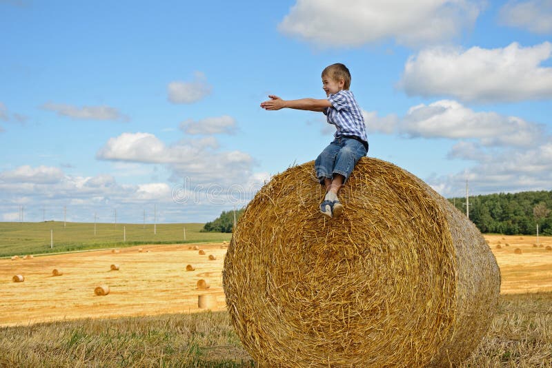 Young Boy Sitting on Haystack Stock Photo - Image of sitting, outdoor ...