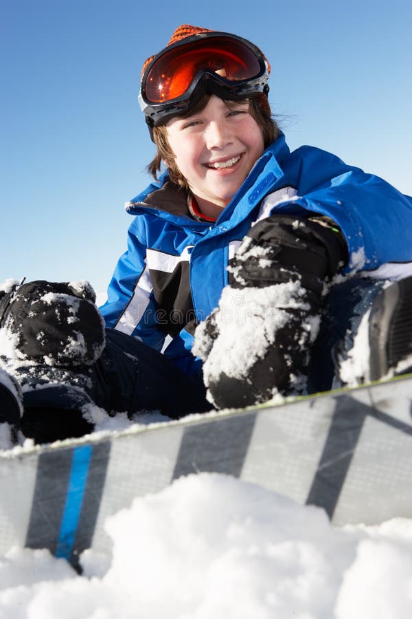 Young Boy Sitting in Snow with Snowboard Stock Image - Image of smiling ...