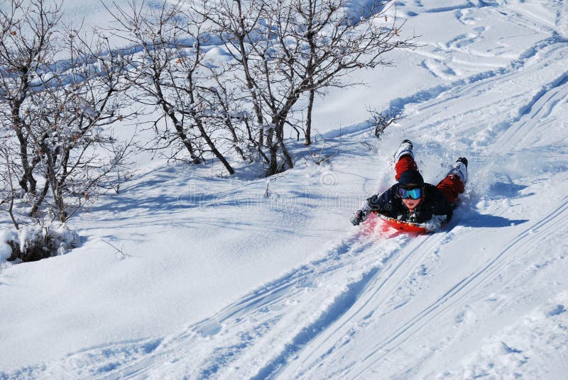 Young boy sledding stock photo. Image of boots, winter - 7799342