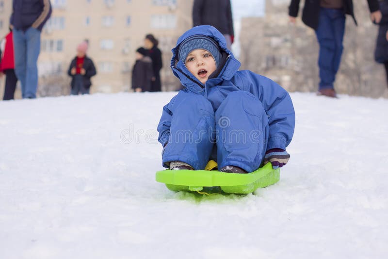 Young boy on sledge stock photo. Image of tobogganing - 37946920