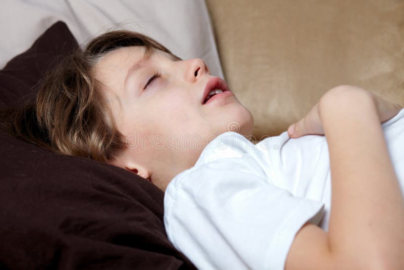 Young boy sleeps on sofa stock image. Image of human - 23185601