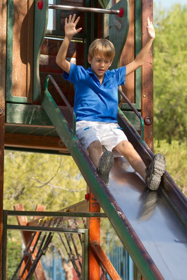 Young Boy on a Slide in the Park Stock Image - Image of funny, enjoying ...