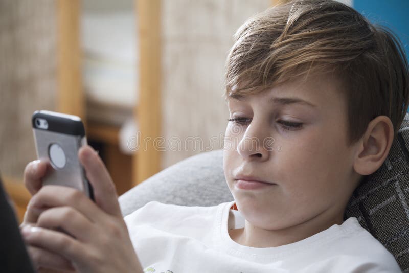 Young boy with smartphone stock image. Image of close - 68945573