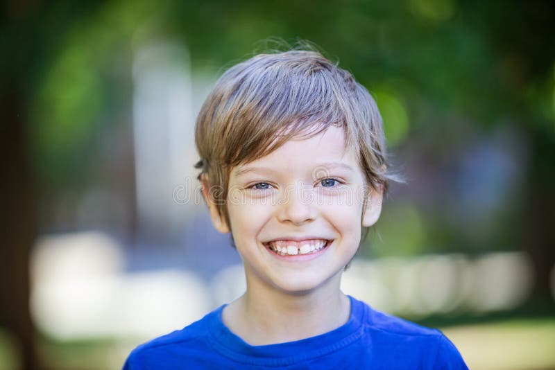 Young Boy Smiling and Looking at Camera in Park Stock Image - Image of ...