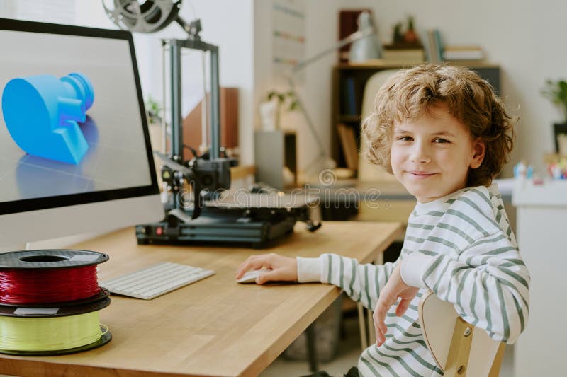 Young Boy Smiling in Technology-Focused Classroom Setting Stock Photo ...