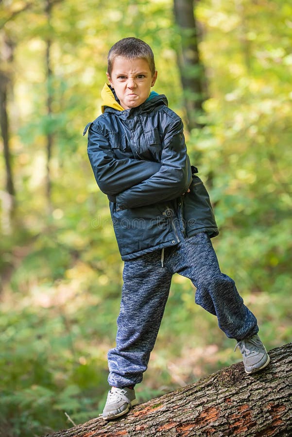 Young Boy Standing on Fallen Down Tree Trunk and Catching Balance Stock ...