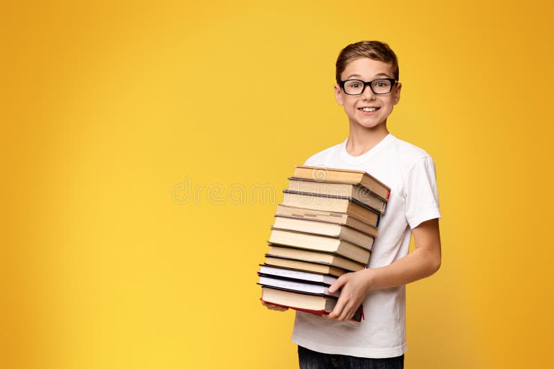 Young Boy Holding Stack of Books Stock Photo - Image of hands, academic ...