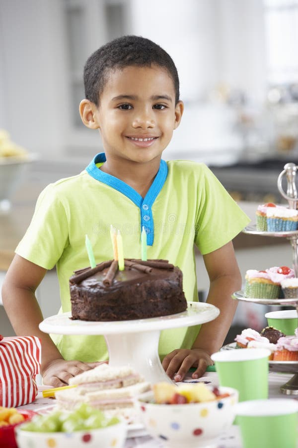 Young Boy Standing by Table Laid with Birthday Party Food Stock Photo ...