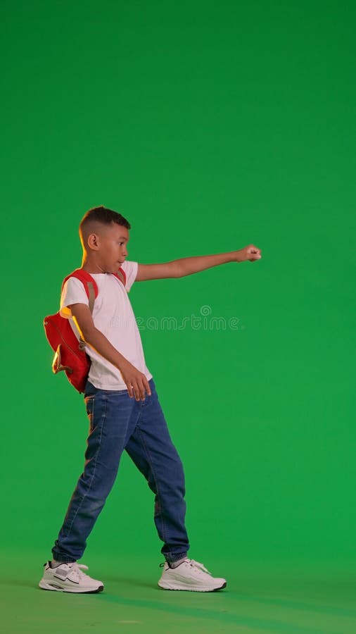 Young Boy Striking a Superhero Pose Against Green Screen Stock Image ...