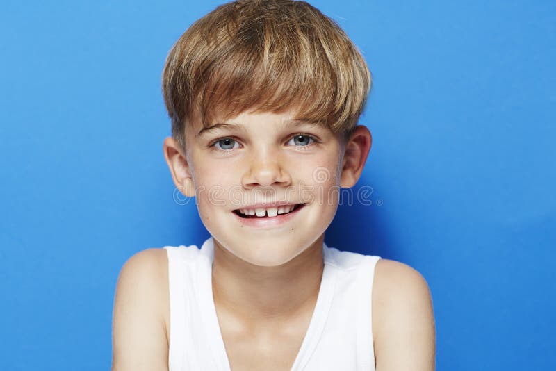 Young Boy in Studio, on Blue Background Stock Image - Image of eyes ...