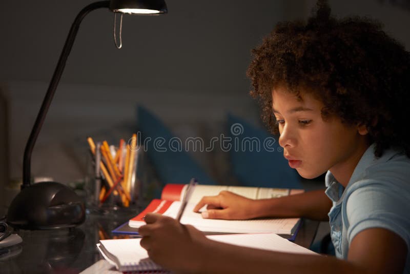 Young Boy Studying at Desk in Bedroom in Evening Stock Image - Image of ...