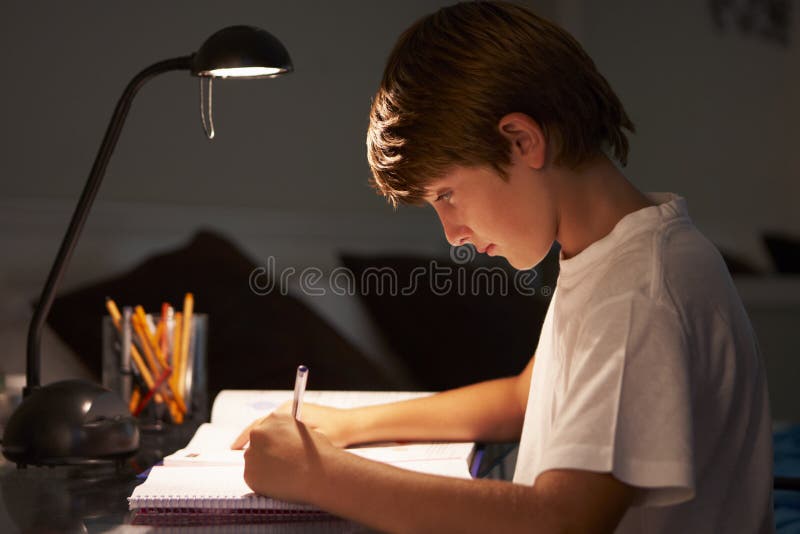 Young Boy Studying at Desk in Bedroom in Evening Stock Image - Image of ...