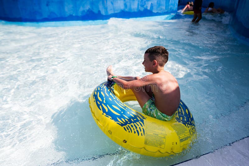 Young Boy Swimming in Pool with Inflatable Ring at Aquapark Stock Photo ...