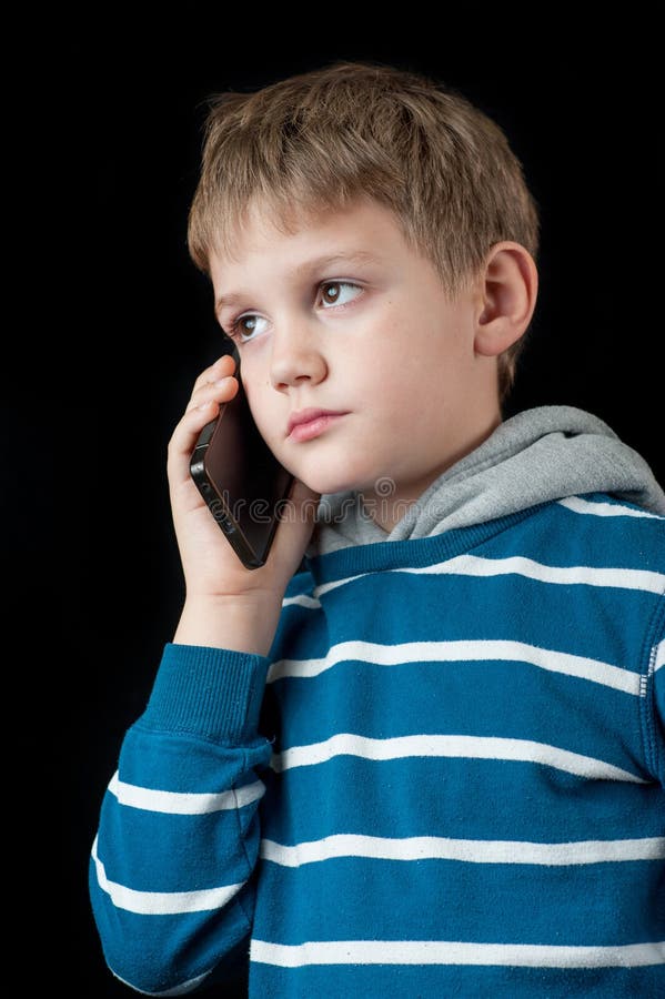Young Boy Talking on Mobile Phone Stock Image - Image of gold, stand ...