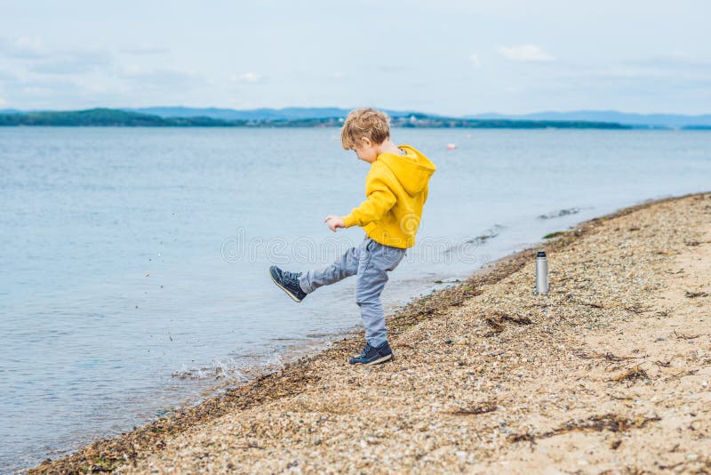 Young Boy Throwing Stones in Sea Water Stock Image - Image of childhood ...
