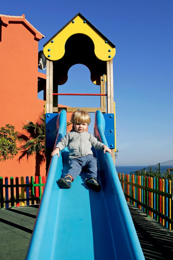 Young Boy or Toddler Coming Down a Slide in the Sun Stock Photo - Image ...