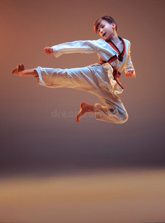 Young Boy Training Karate on Blue Background Stock Photo - Image of ...
