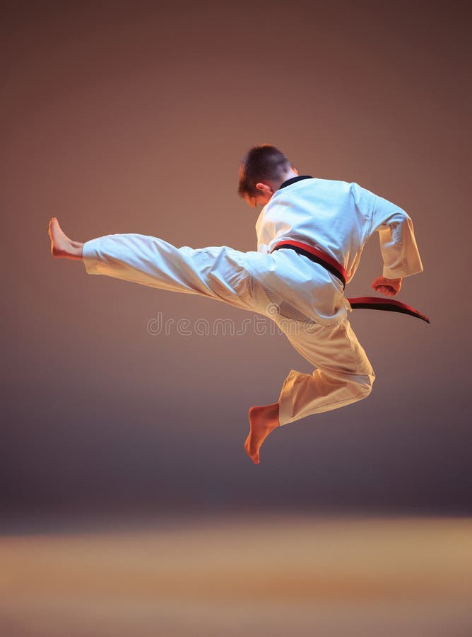Young Boy Training Karate on Blue Background Stock Photo - Image of ...