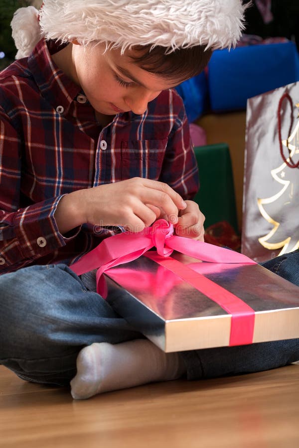 Young Boy Unpacking Present Stock Image - Image of happy, claus: 35343411