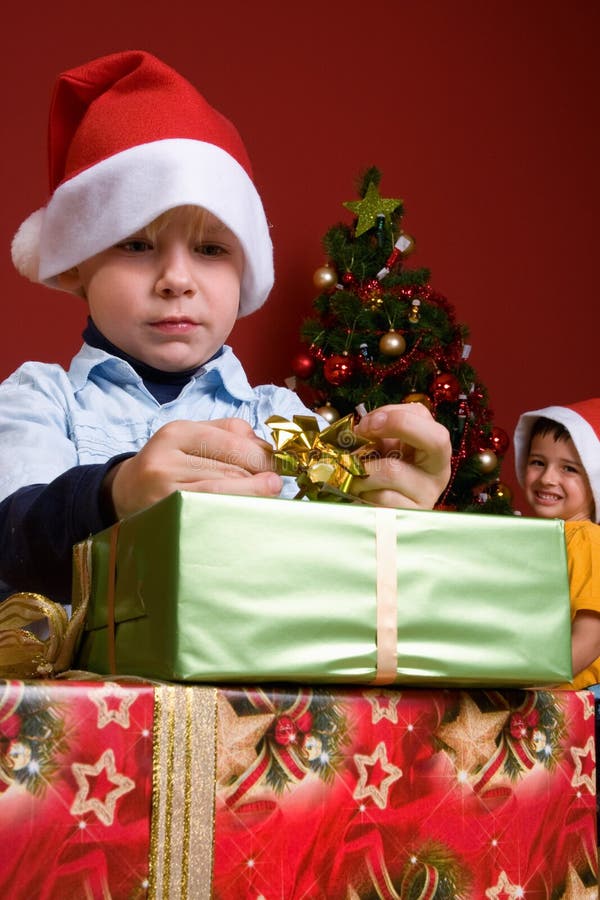 Young Boy Unwrapping Christmas Gift Stock Photo - Image of gift, female ...