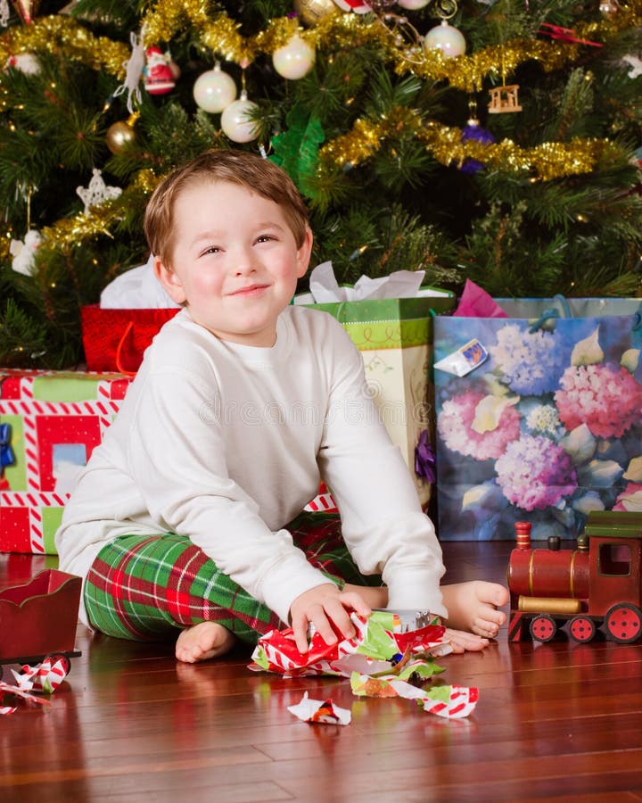 Young Boy Unwrapping Presents Stock Image - Image of ornament ...