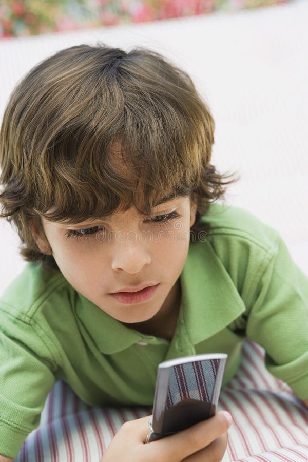 Young Boy Using Cell Phone stock image. Image of casual - 29662543