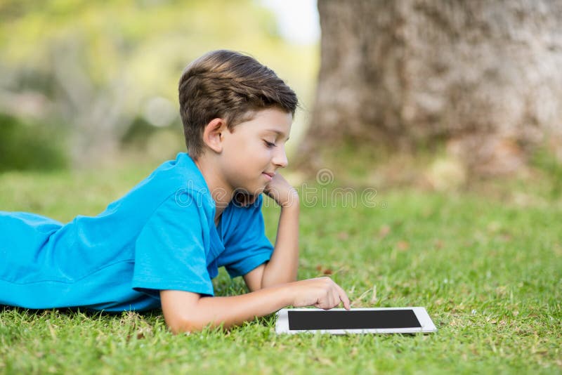 Young Boy Using Digital Tablet in Park Stock Image - Image of internet ...