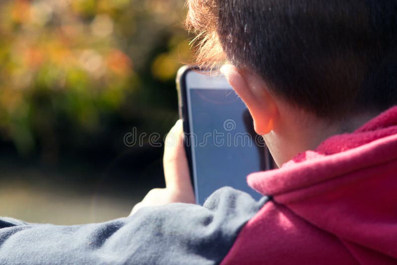 Young Boy Using Phone Outdoors Stock Image - Image of cell, childhood ...