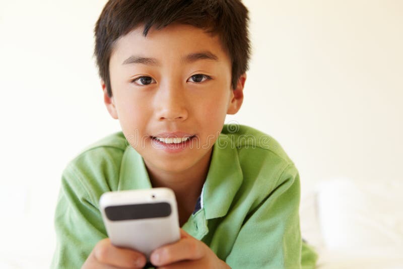 Young boy using smartphone stock image. Image of cell - 54950361