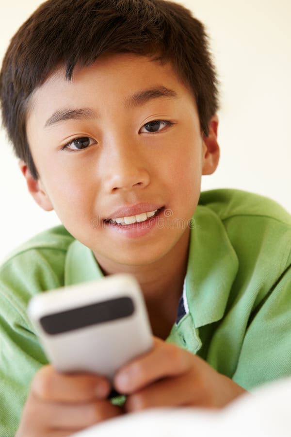 Young boy using smartphone stock photo. Image of message - 54951962