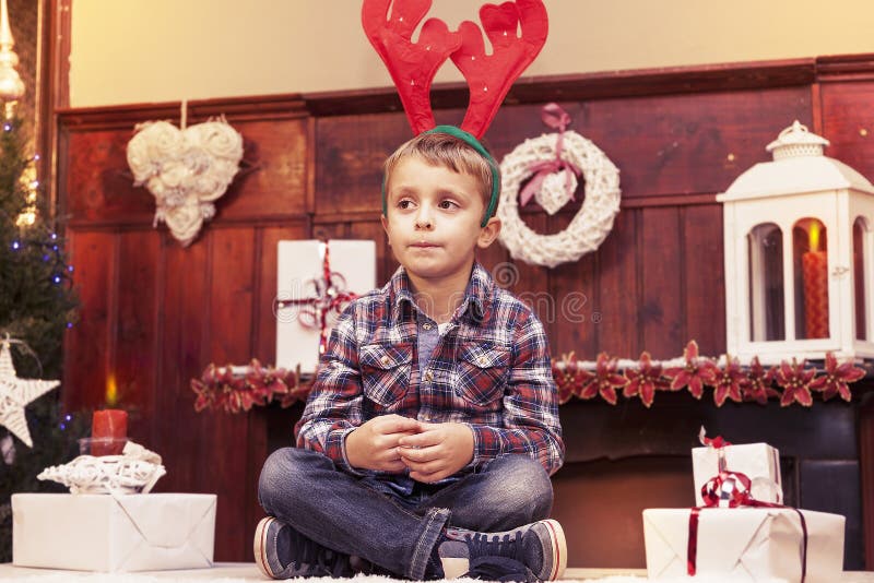 Young Boy Waiting for Santa Claus Stock Photo - Image of horns ...