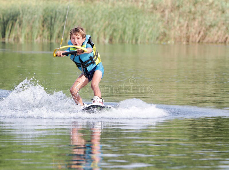 Young boy wakeboarding stock photo. Image of boating - 33134378
