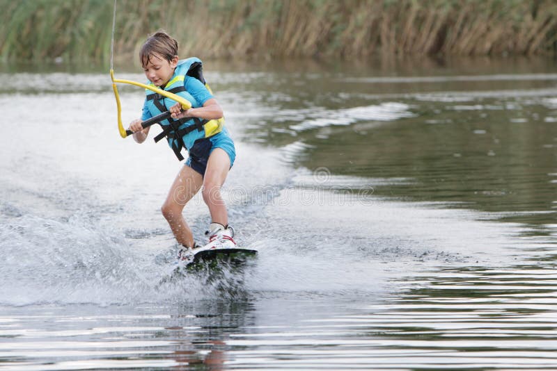 Young boy wakeboarding stock image. Image of childhood - 33134437