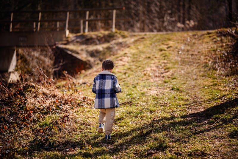 Young Boy Walking Outdoors on a Gravel Path Stock Image - Image of ...
