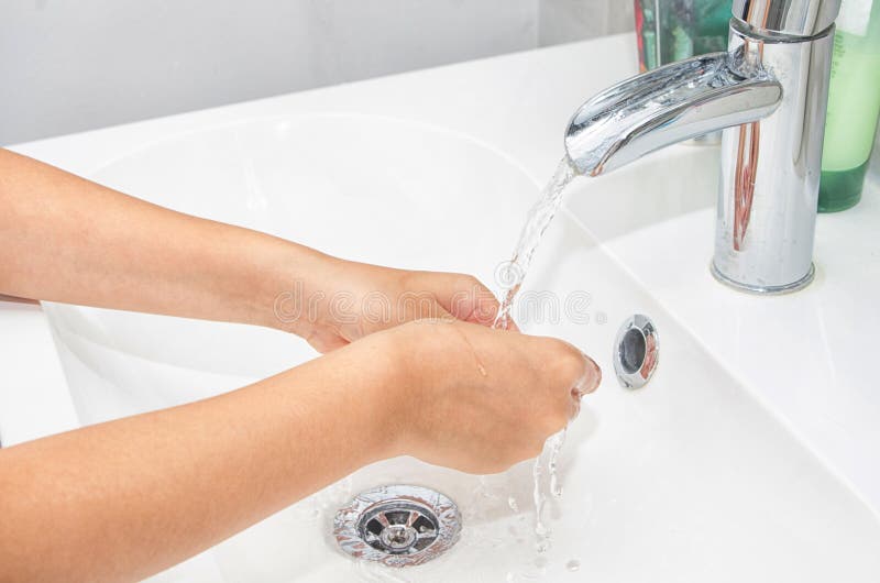 Washing of Both Hands with Soap Under a Yellow Wash Basin with Running ...