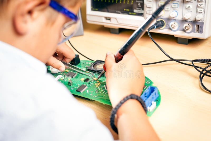Young Boy Working on an Electronics Project Stock Image - Image of ...
