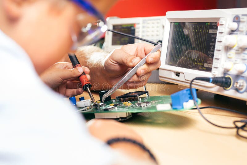 Young Boy Working on an Electronics Project Stock Photo - Image of ...