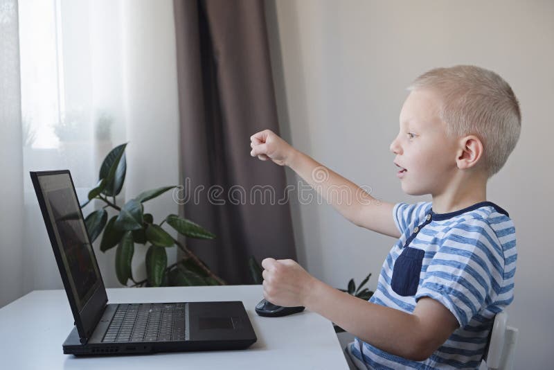 Young Boy Working or Playing on a Computer at Home. E-lessons ...