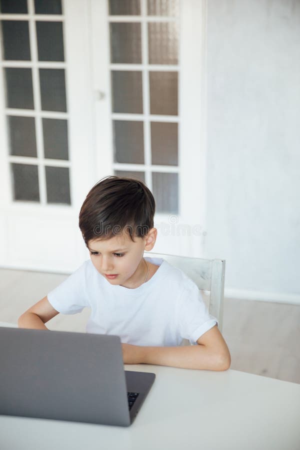 Smart Young Boy Works on a Laptop for His New Project in His Computer ...