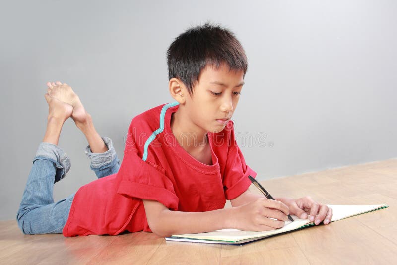 Young Boy Writing on the Floor Stock Photo - Image of knowledge, floor ...